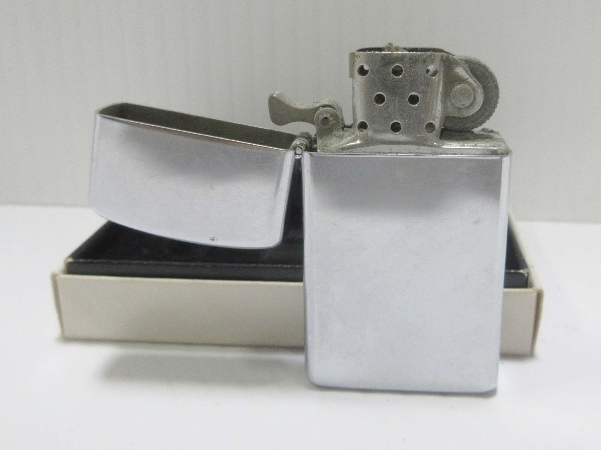 Albrecht Auctions | Small Silver-Tone Zippo Lighter