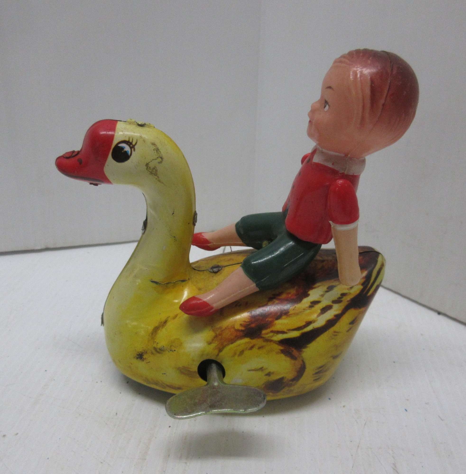 Albrecht Auctions | Fishing Boy on a Swan Wind-Up Toy, Has Key